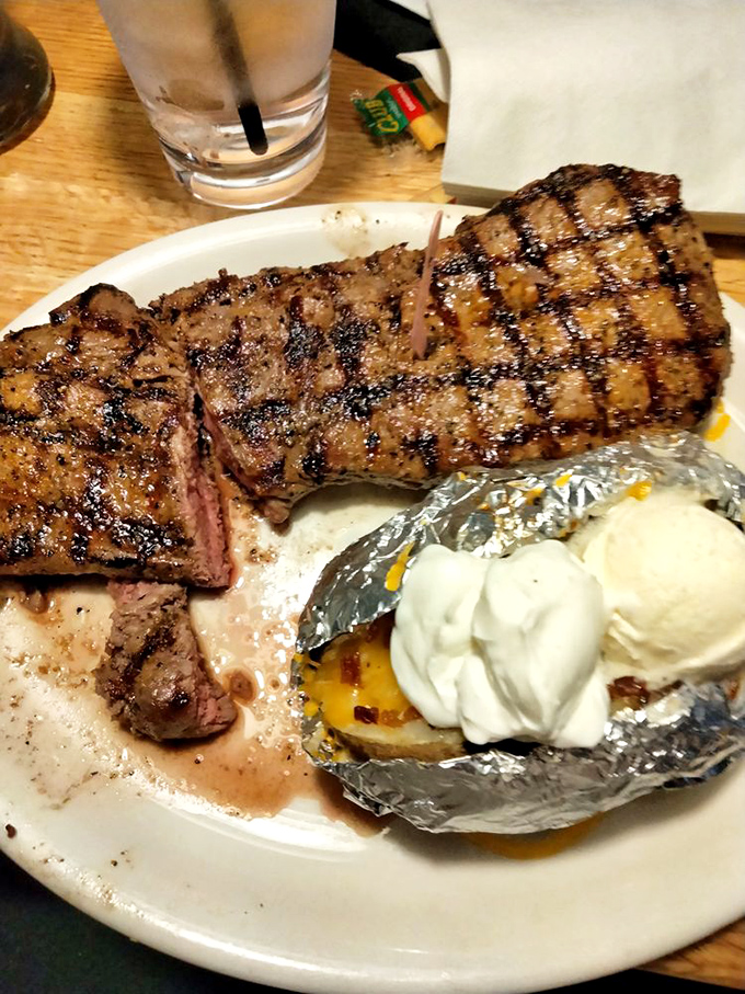 A perfectly grilled sirloin with those coveted crosshatch marks sits alongside a loaded baked potato. This isn't just dinner; it's a celebration.