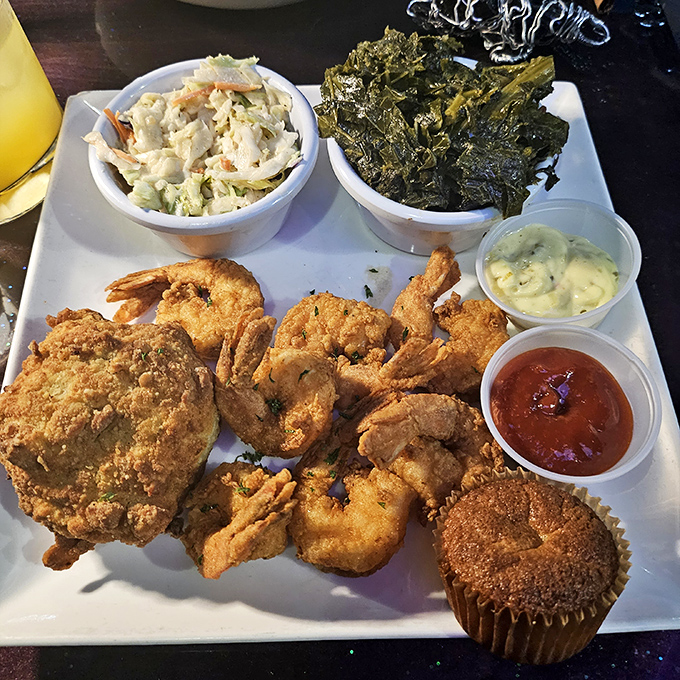 Soul food symphony on a plate&mdash;crispy seafood, creamy coleslaw, and collard greens that would make your grandmother nod in approval.