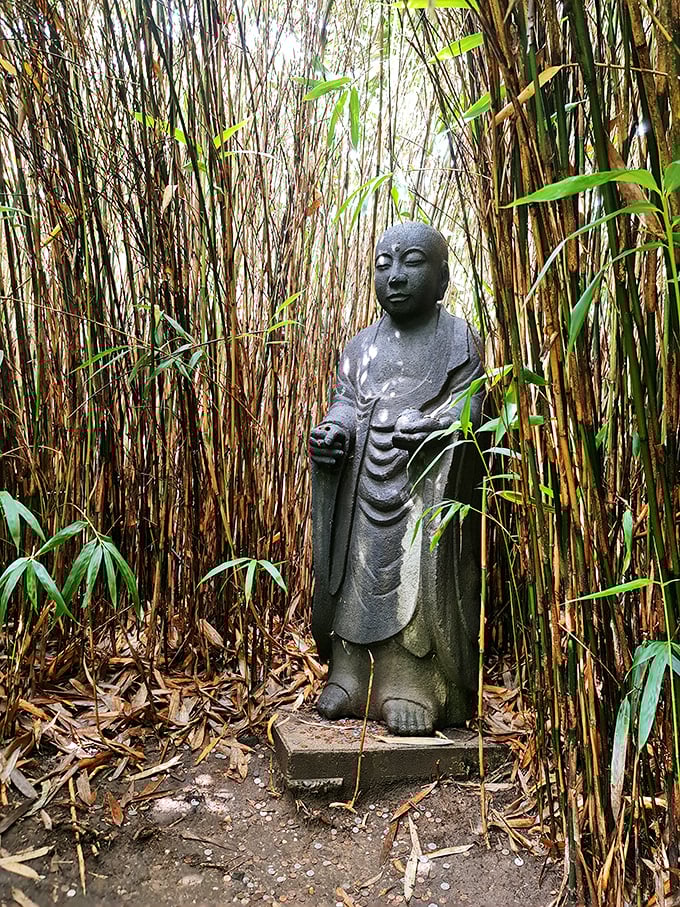 Hidden among bamboo stalks, this stone figure has achieved what we all secretly want: perfect serenity despite being surrounded by tourists.