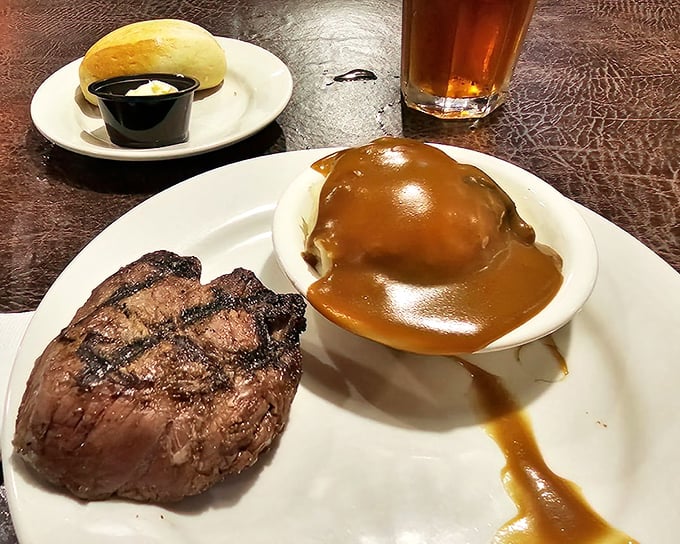 Simplicity perfected: a beautifully seared steak alongside a potato drowning happily in gravy&mdash;comfort food that speaks fluent Virginian.