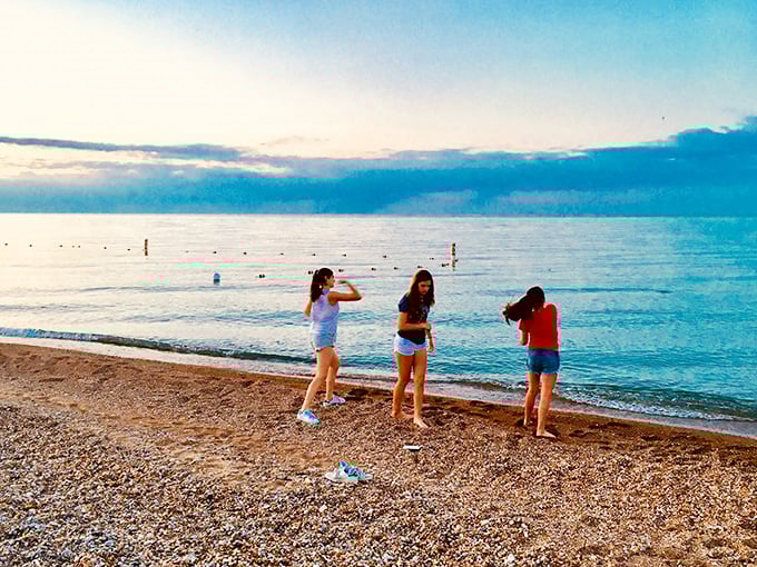 Twilight transforms the shoreline into nature's theater. These beachgoers know the secret&mdash;Glencoe's evening light show rivals anything on Broadway, and the tickets are free.
