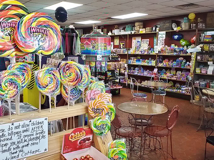 Whirly Pops bigger than your face stand guard like colorful sentinels. The sign politely reminds adults that breaking one means you've bought it.