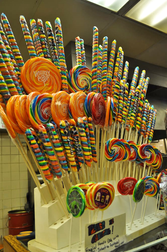 Whirly pops standing at attention like a colorful army of sweetness, each one promising a spiral journey into pure childhood bliss.