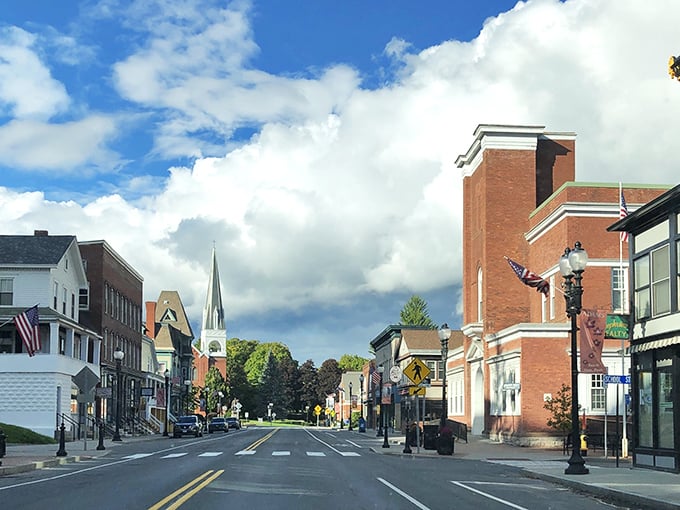 Stroll down the historic streets of Adams, where charming brick architecture and towering steeples greet you under a bright sky.