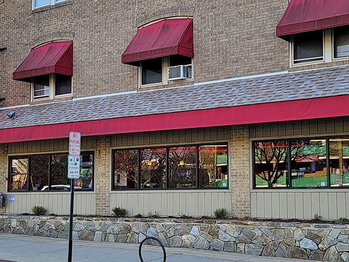 Gianni's red awnings welcome pizza lovers into a world where cheese stretches for days and sauce sings with flavor.