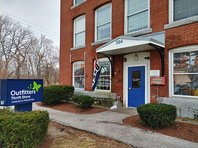 Housed in a historic brick building with a welcoming blue door, Outfitters Thrift Store combines architectural charm with bargain hunting.