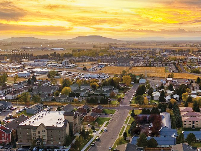 Rexburg's peaceful neighborhoods spread beneath the watchful gaze of distant mountains, offering affordable serenity.