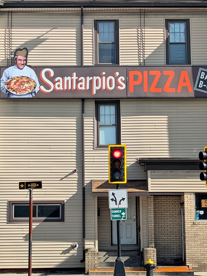 Santarpio's sign stands proud against a classic New England backdrop &ndash; it's not trying to impress you until that first magical bite.