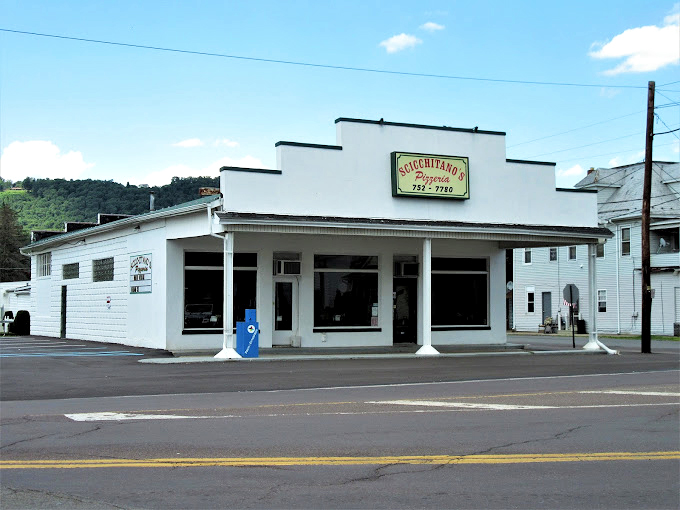 Scicchitano's Pizzeria: White building, blue skies, and picnic tables where pizza memories are made. Norman Rockwell would approve.