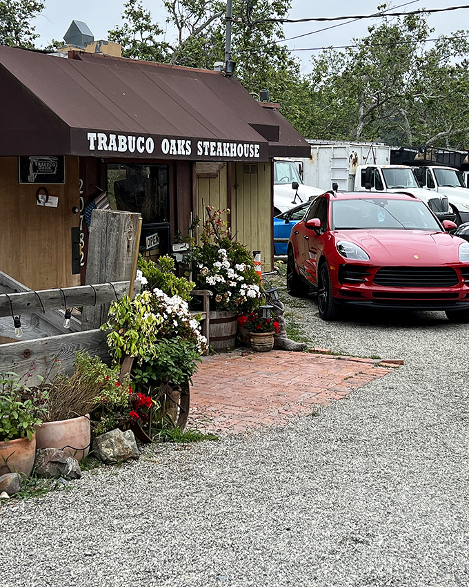 Trabuco Oaks Steakhouse greets visitors with flower-filled barrels and a rustic charm that whispers, "The city is far behind you now."