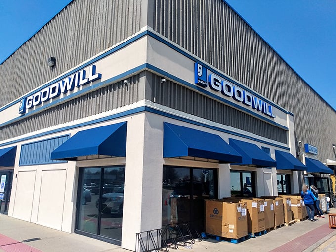 Blue awnings and big dreams at Champaign's Goodwill. Those stacked boxes outside hint at fresh treasures waiting to find their forever homes inside.