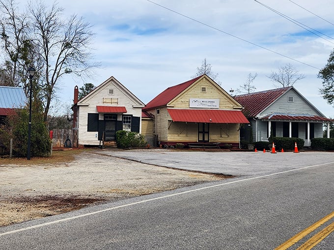 The weathered wood and red metal roof of Mill Pond Steakhouse whisper tales of countless memorable meals. Rural dining at its finest.
