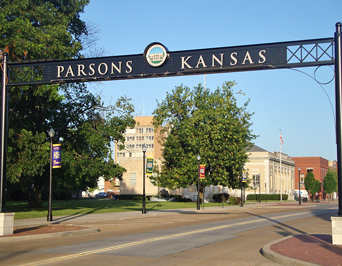 The Parsons welcome arch frames the town's civic buildings like a portal to small-town America—simple, dignified, and welcoming.