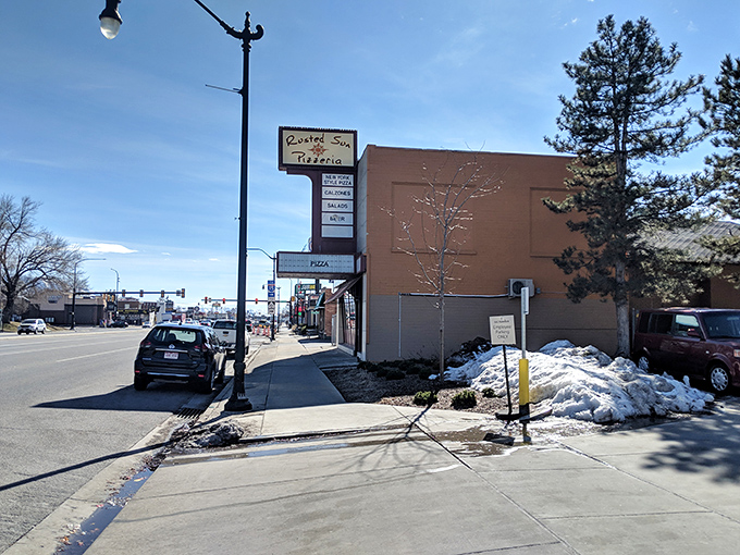 Snow melting on the sidewalk outside Rusted Sun - nothing warms a Utah winter like the promise of perfect pizza.