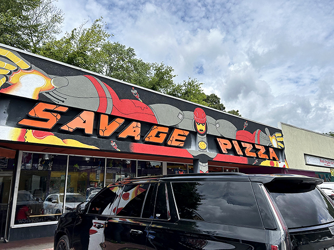 The bold, graphic facade of Savage Pizza promises pizza with personality. That superhero mural hints at the adventure waiting inside.