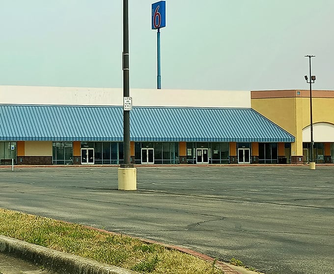 A Motel 6 sign stands sentinel near the Shoppes at Seymour, where road-trippers find unexpected retail therapy between destinations.