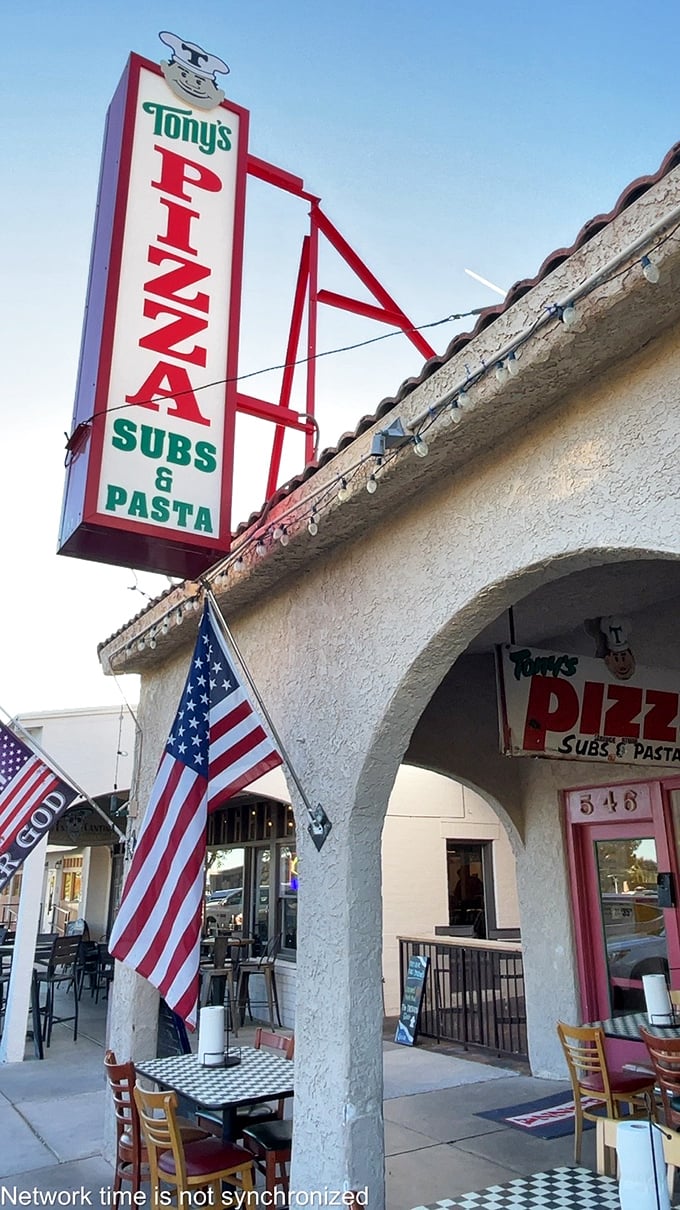 The American flag flies proudly outside Tony's Pizza, where patriotism and perfect pies go hand in hand. 