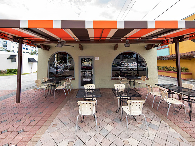 Under Tucci's striped awning, outdoor tables invite you to savor that perfect char only coal fire can deliver&mdash;Florida sunshine included.