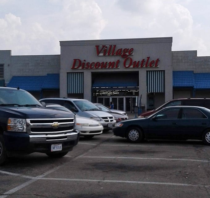 The white and blue facade of Village Discount Outlet &ndash; where wallet-friendly adventures begin daily.