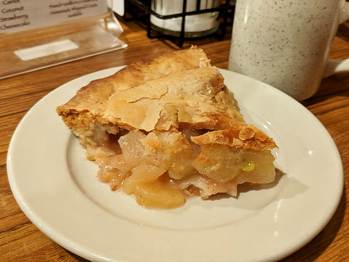 A slice of apple pie that would make your grandmother simultaneously proud and jealous. That golden crust practically whispers sweet nothings.
