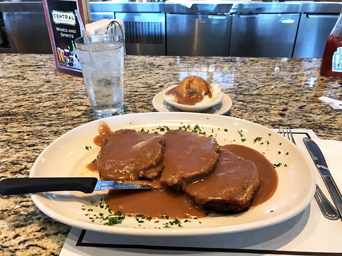 Three slices of meatloaf perfection swimming in a lake of gravy. This isn't just dinner; it's the reason elastic waistbands were invented.