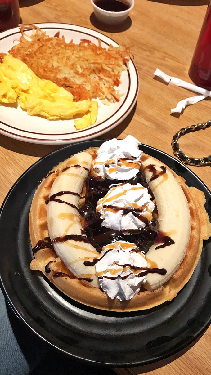 The banana waffle with whipped cream and chocolate drizzle proves that sometimes breakfast and dessert are simply two sides of the same delicious coin.