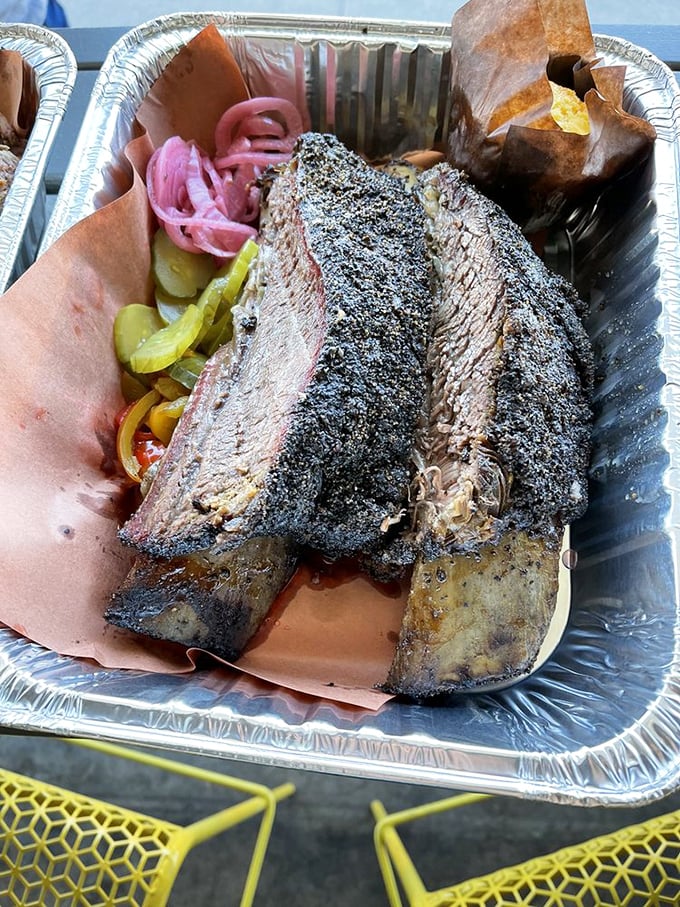 Beef ribs that Fred Flintstone would fight you for, accompanied by house-made pickles that cut through the richness perfectly.