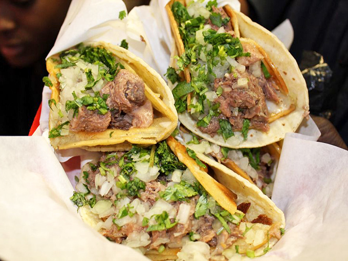 Tacos that speak the universal language of deliciousness. Double corn tortillas cradle perfectly seasoned meat topped with the holy trinity: onions, cilantro, and salsa.