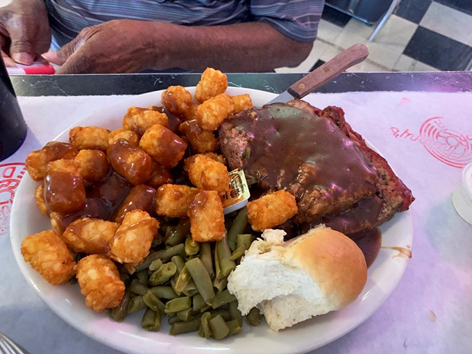 Tater tots so perfectly golden they deserve their own Grammy. The meatloaf's tangy glaze caramelizes at the edges &ndash; that's where the magic happens.