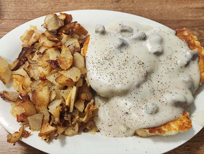 These home fries could make a potato proud, while the sausage gravy blankets a biscuit like a warm Southern hug on a plate.