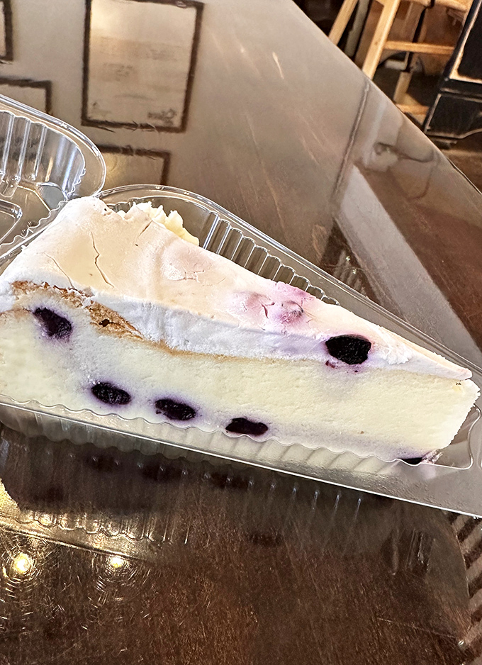 Blueberries suspended in creamy cheesecake like edible jewels. This slice doesn't just get eaten&mdash;it gets remembered in dreams for years to come.