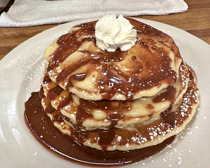 Pancakes wearing their best outfit &ndash; dressed in caramel, whipped cream, and powdered sugar for a breakfast that blurs the dessert line beautifully.