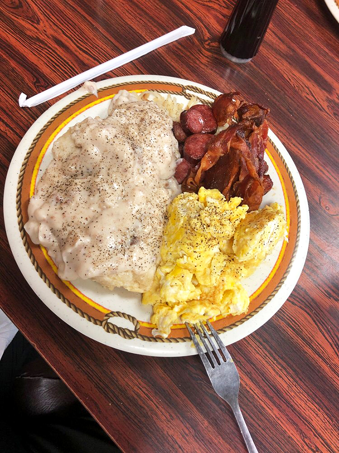 Breakfast of champions! Country gravy blankets a biscuit while scrambled eggs and bacon stand ready to fuel your day of Florida adventures.