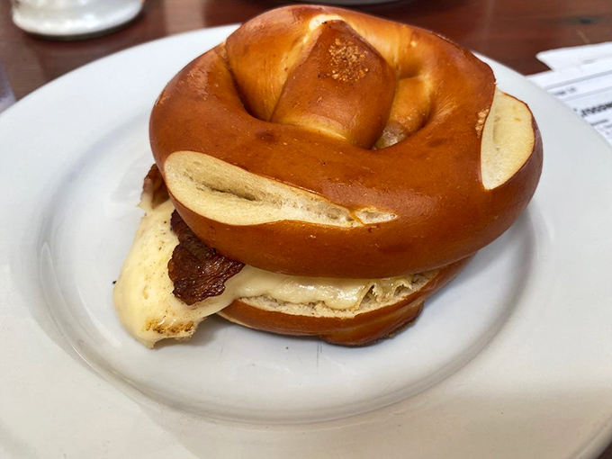 The pretzel breakfast sandwich: where German tradition meets American morning cravings in a glossy, chewy package that puts ordinary bread to shame. 