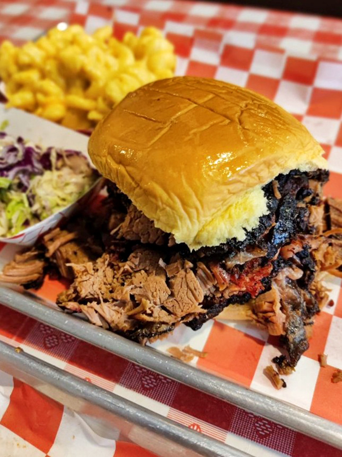 Not so much a sandwich as a structural engineering marvel. The bun heroically attempts to contain a mountain of brisket while coleslaw provides moral support.