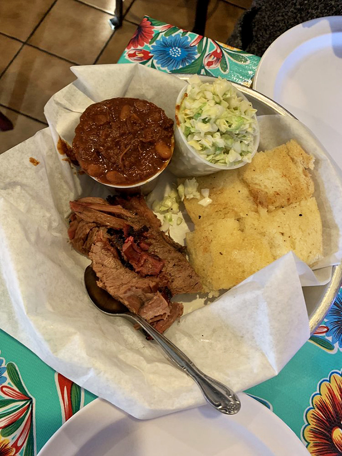 A barbecue trinity that would make angels sing: smoky brisket, hearty beans, and coleslaw that cuts through the richness just right.