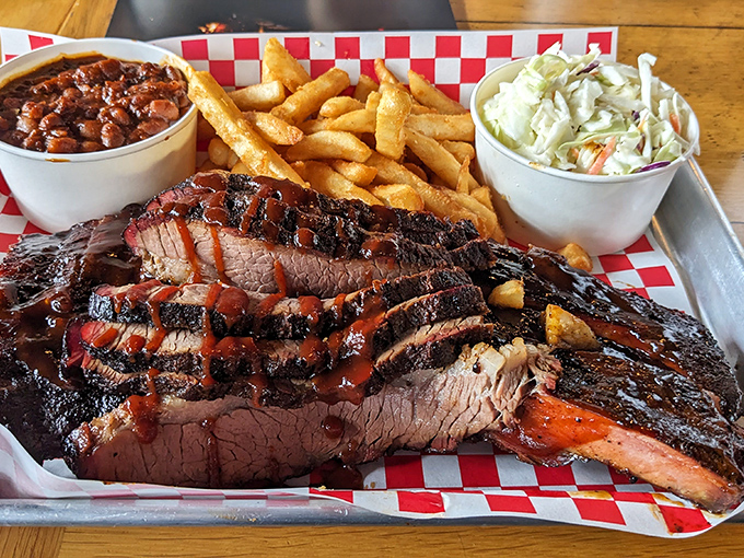 Behold the brisket platter: where tender meat meets classic sides in perfect barbecue harmony. 