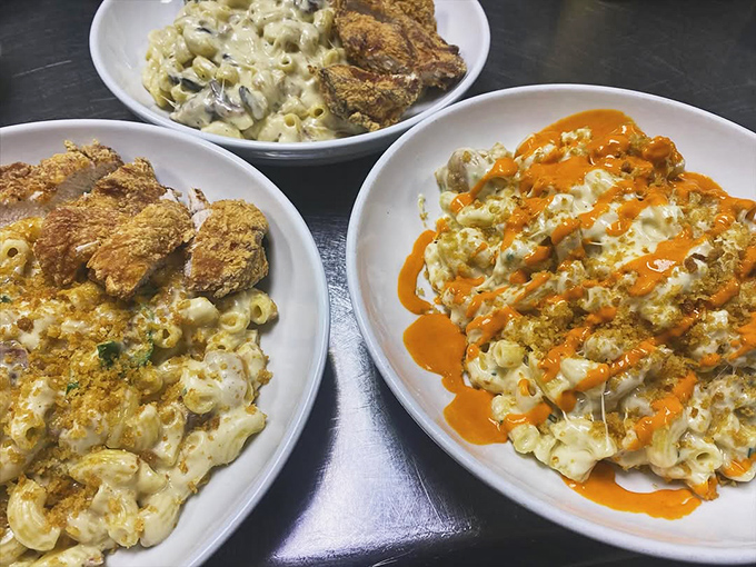 The mac and cheese trifecta! One topped with crispy chicken, another with buffalo sauce. It's not a competition, but everyone wins.