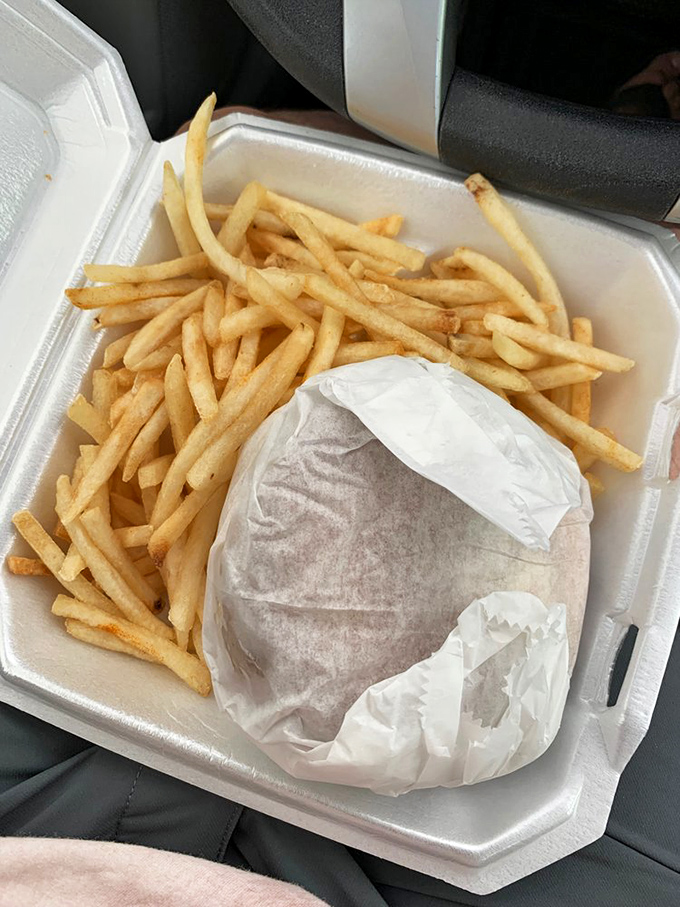 Car dining at its finest—the universal lap napkin arrangement we all know too well. Some of life's best meals happen behind a steering wheel.