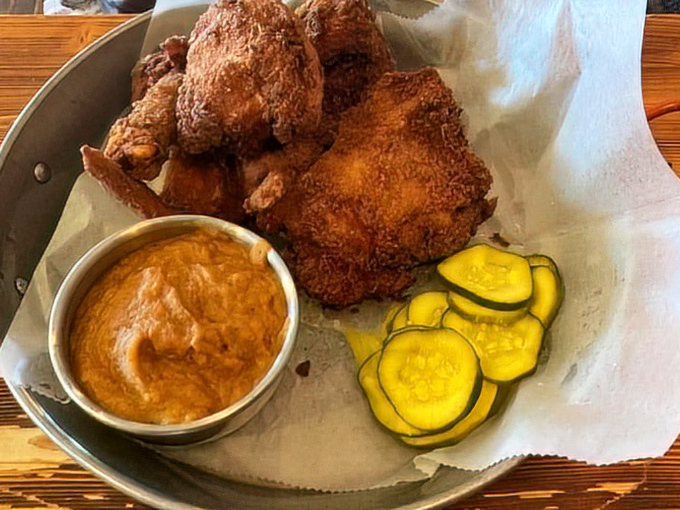 The perfect fried chicken trifecta: crispy exterior, juicy interior, and those house-made pickles cutting through the richness. A holy trinity of flavor.