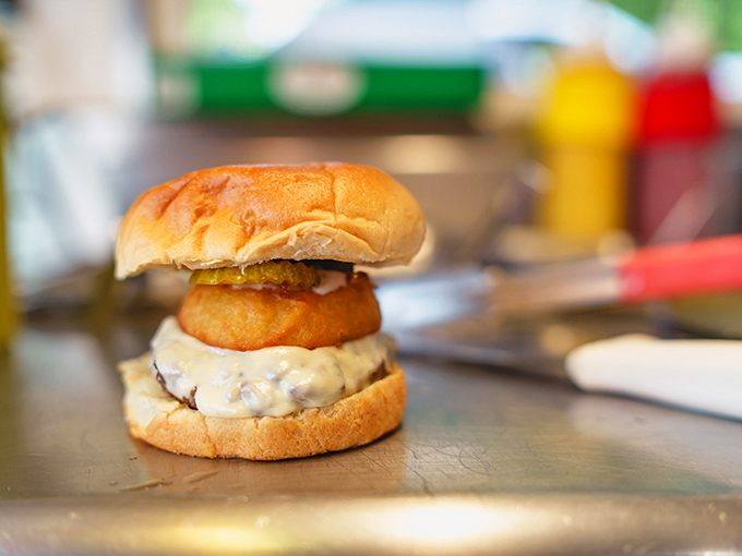 This isn't just a burger &ndash; it's architecture. The onion ring crown adds both nobility and that perfect crunch factor.