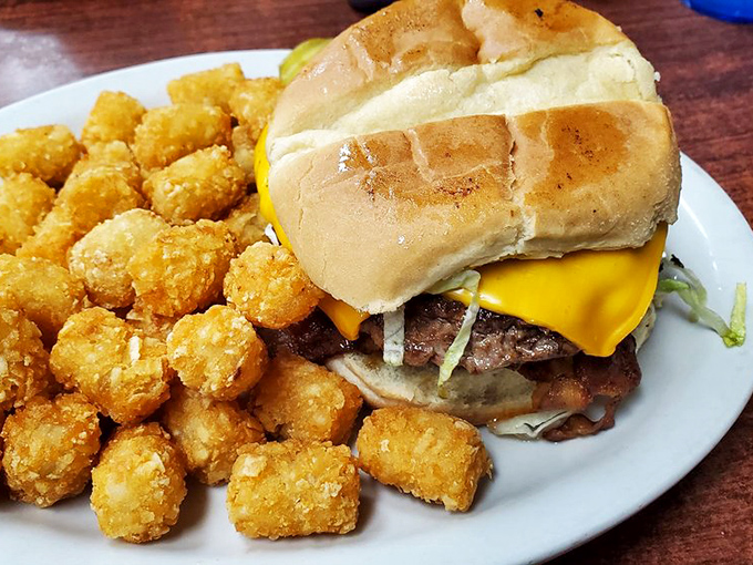The cheeseburger and tater tots combo is comfort food algebra: simple elements combining to create something greater than the sum of its parts.