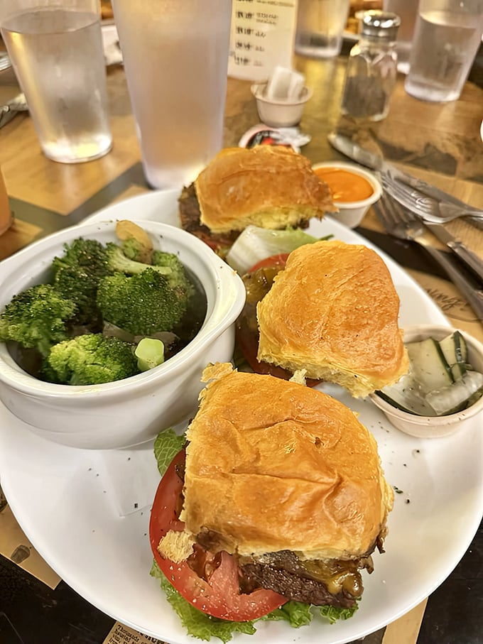 Slider trio perfection with a side of broccoli for those who believe in balance. The golden buns practically whisper, "Take a bite already!"