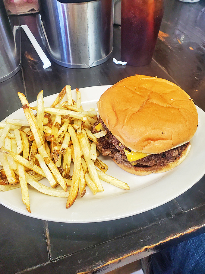The classic cheeseburger and fries combo&mdash;proof that simplicity, when executed perfectly, can be the highest form of culinary art.