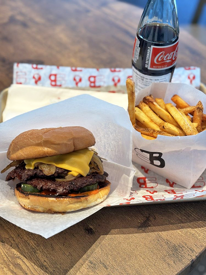 The holy trinity of dining happiness: a perfectly constructed burger, golden fries, and an ice-cold Coca-Cola. Some traditions transcend cultures.