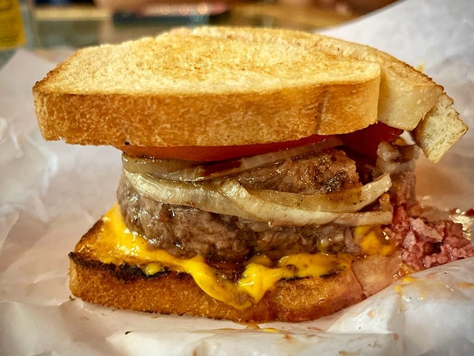 The cross-section reveals the truth: a perfectly medium-rare interior, melty cheese, and fresh toppings. This isn't fast food; it's slow food that was worth the wait.
