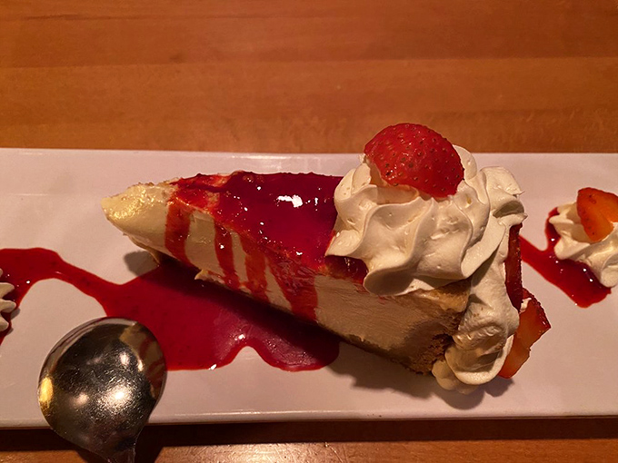 Cheesecake draped in berry sauce and crowned with whipped cream. This slice isn't just dessert&mdash;it's the grand finale your taste buds have been rehearsing for all evening.