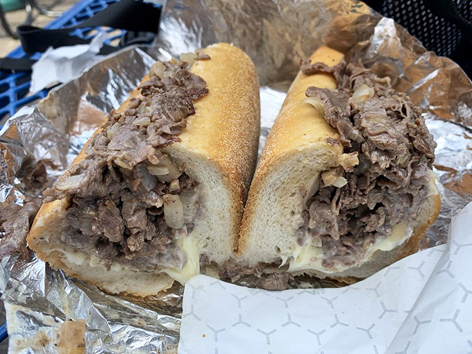 The cheesesteak that launched a thousand road trips, glistening with beefy promise and wrapped like the edible gift it truly is.