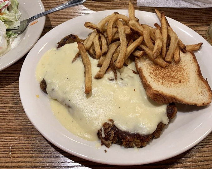 Chicken fried steak smothered in creamy gravy with golden fries&mdash;the kind of plate that makes diets spontaneously combust upon arrival.