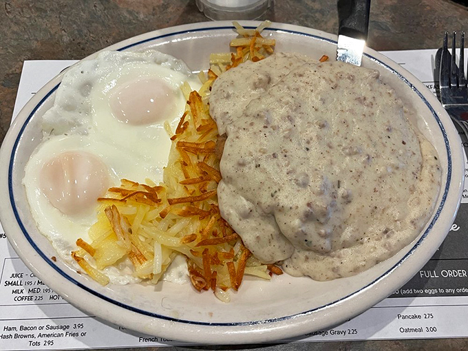 Breakfast nirvana on a plate. The sausage gravy blankets the chicken fried steak like a warm hug, while those hash browns achieve the perfect crisp-to-tender ratio.